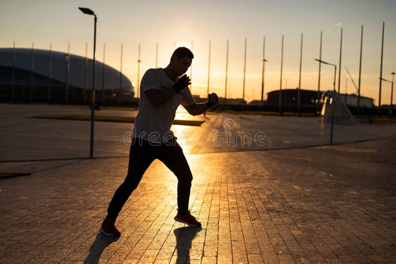 A Man Trains Boxing at Sunset Outdoors. Stock Photo - Image of ...