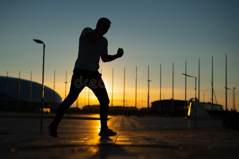 A Man Trains Boxing at Sunset Outdoors. Stock Image - Image of fist ...