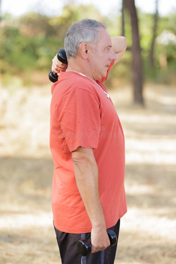 Man Trains with Dumbbells Outdoors Stock Photo - Image of fresh ...