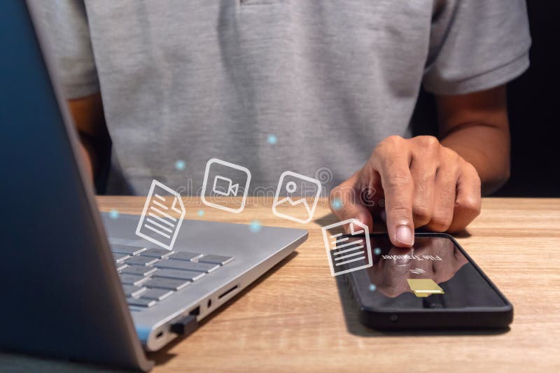 A Man Transfer Files between Mobile Phone and Laptop. Backup, Copy File ...