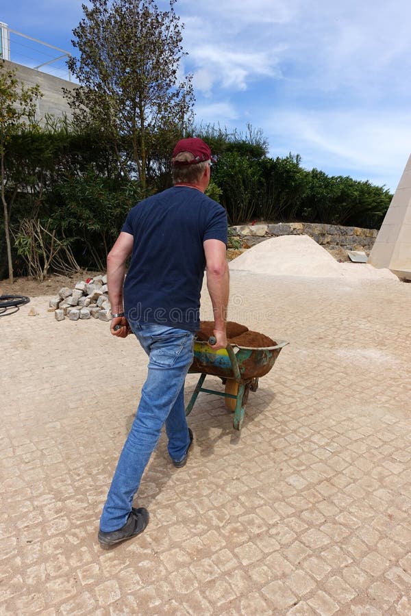 Man Transporting Rolls of Turf Stock Image - Image of working, standing ...