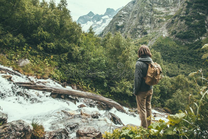 Man Traveler Alone with Backpack Looking at Mountain River among Green ...