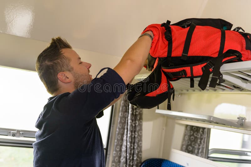 Man Traveling by Train Looking in Backpack Stock Photo - Image of male ...
