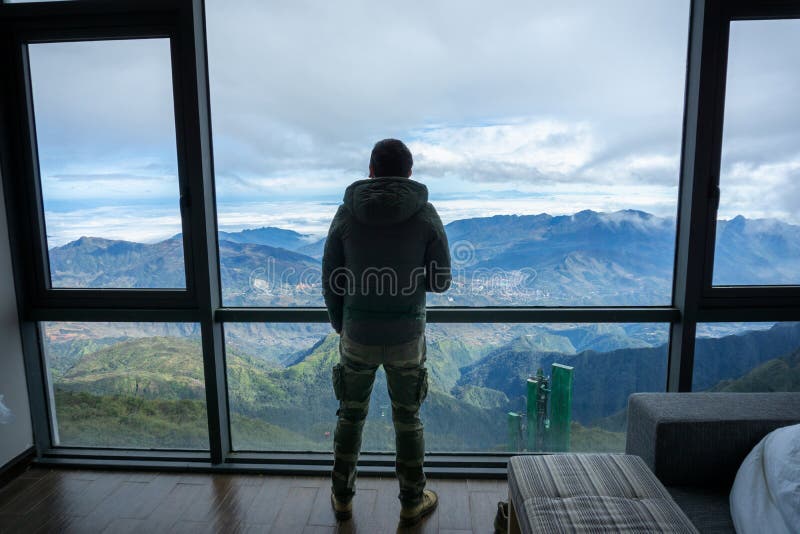 Man Travelller Overlooking the Mountain View from Hotel Window Stock ...