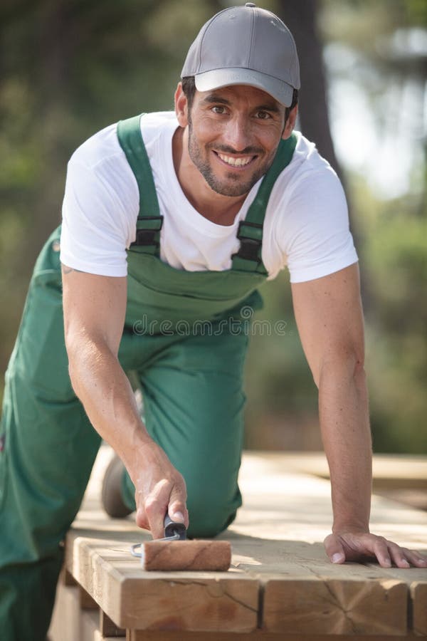 Man Treating Wood Using Paint Roller Stock Photo - Image of paint ...