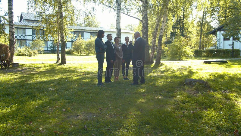 Man with Tree Branch Explain Something To Collegues. Stock Image ...