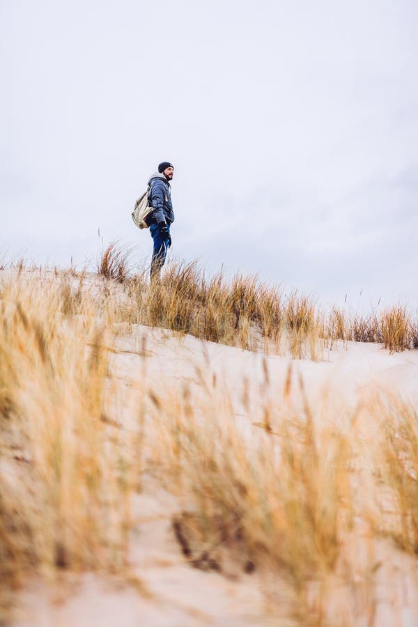 Man Trekking on Dunes by the Sea at Autumn Stock Image - Image of ...