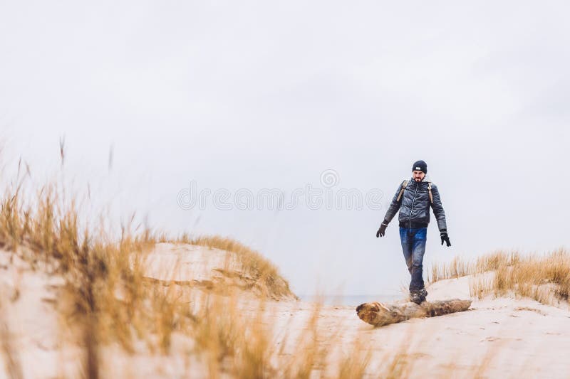 Man Trekking on Dunes by the Sea at Autumn Stock Image - Image of ...