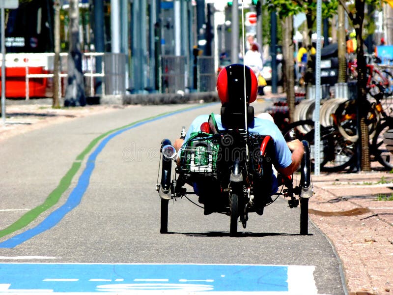 Man on Tricycle on Divided Asphalt Bicycle and Pedestrian Path Stock ...