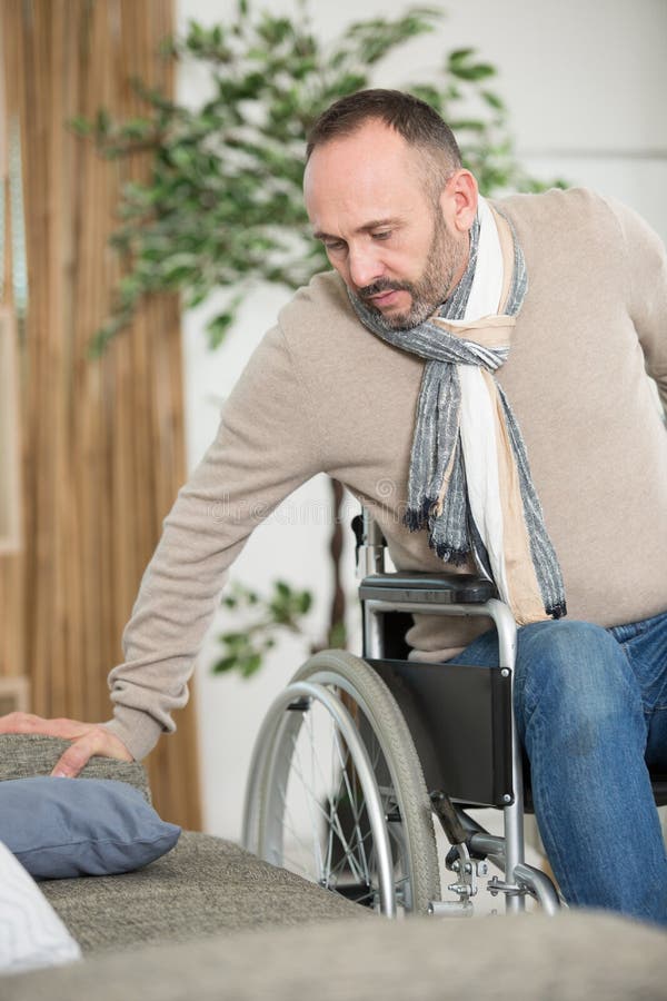 Man Tries To Sit Down on Sofa Stock Photo - Image of flat ...