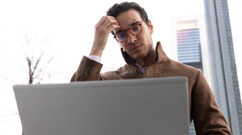 A Man Tries To Solve a Work Problem by Looking at the Computer Screen ...