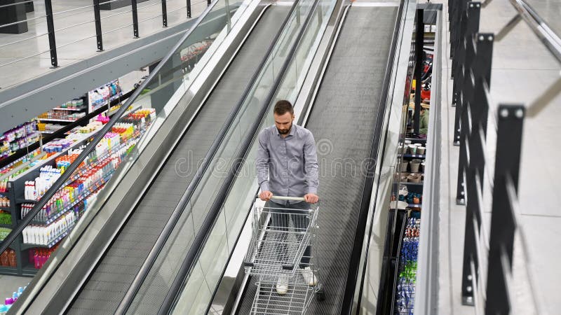 A Man with a Trolley on Escalator in a Hardware Store Stock Footage ...