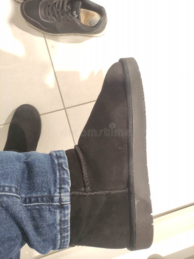 Man Trying on Black Winter Boots in a Store Stock Photo - Image of ...