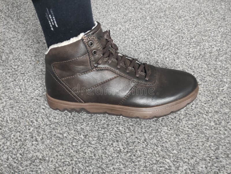 Man Trying on Brown Winter Boots in a Store Stock Photo - Image of ...
