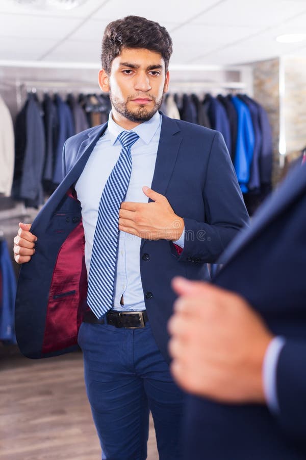 Man trying on jacket stock photo. Image of clothing - 306828242