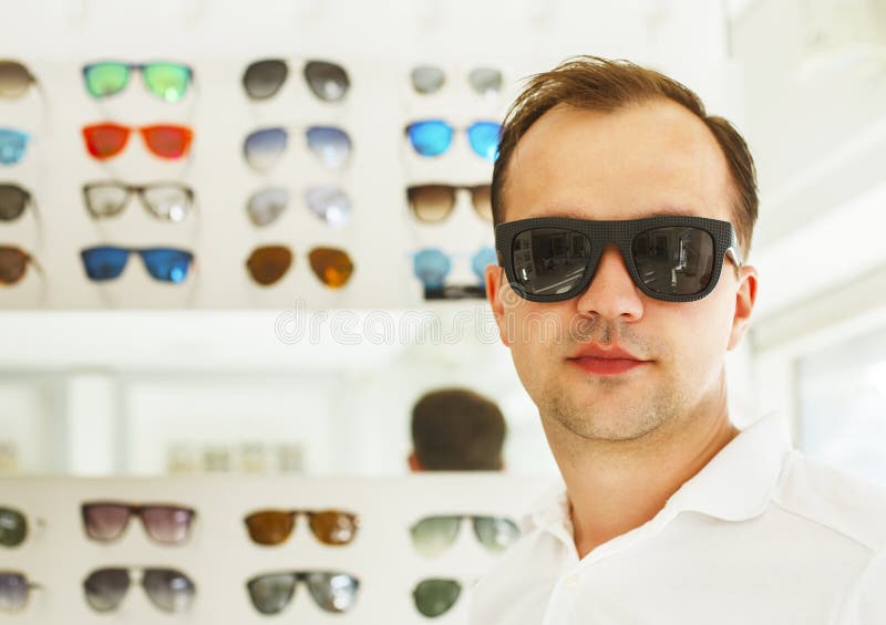 Man Trying on New Sunglasses at the Opticians Stock Image - Image of ...