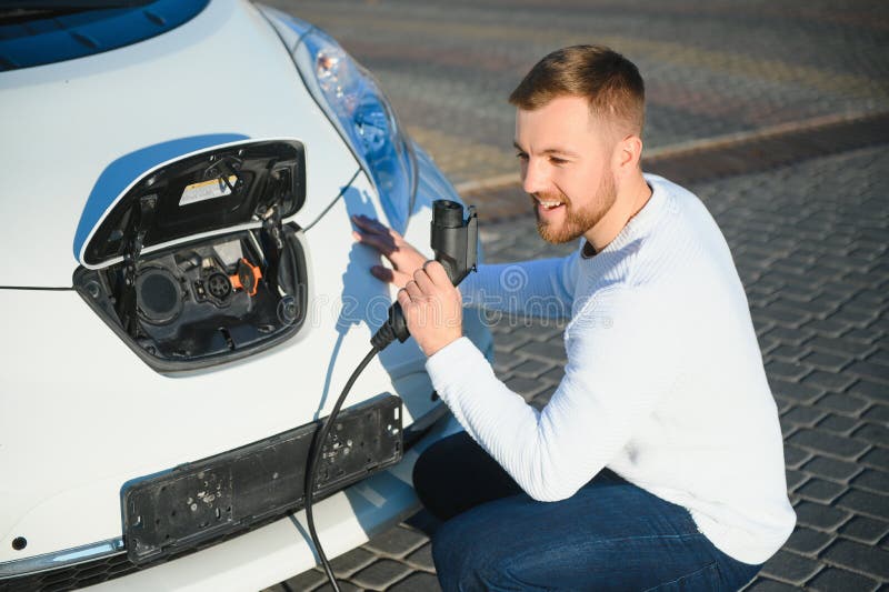 Man Turning on Charging of Car Stock Photo - Image of environment ...