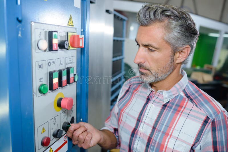 Man turning on machine stock photo. Image of process - 88084082