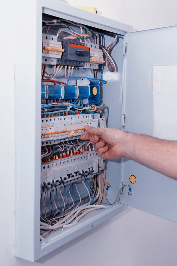The Man Turns on the Electric Switch. Checking Electrical Equipment in ...