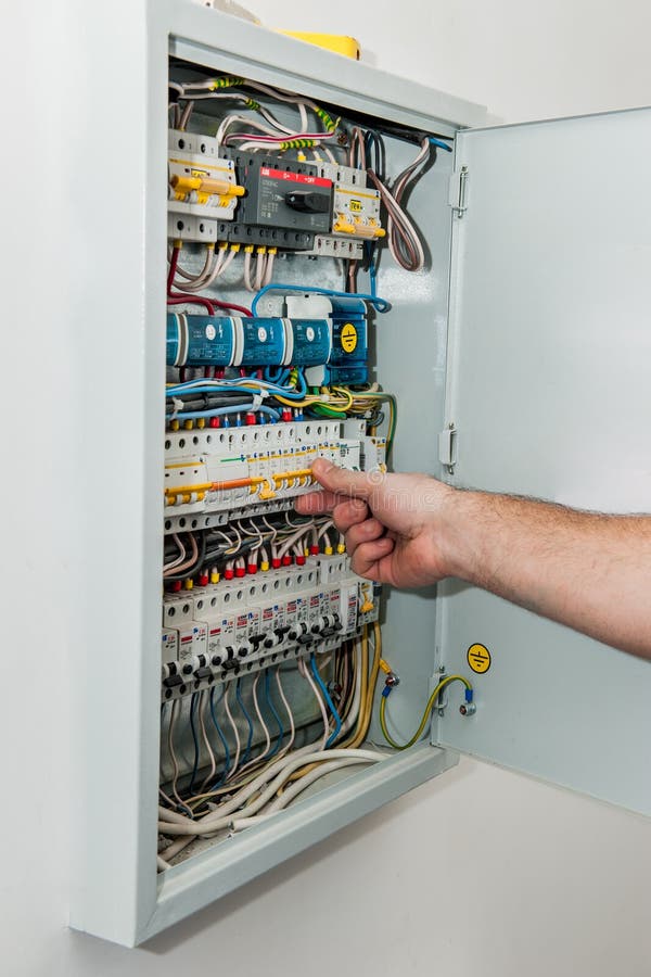 The Man Turns on the Electrical Switch on the Electrical Distribution ...
