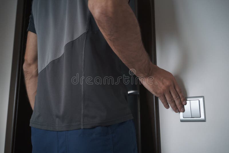 Man Turns Off the Light when Leaving the Room Stock Image - Image of ...