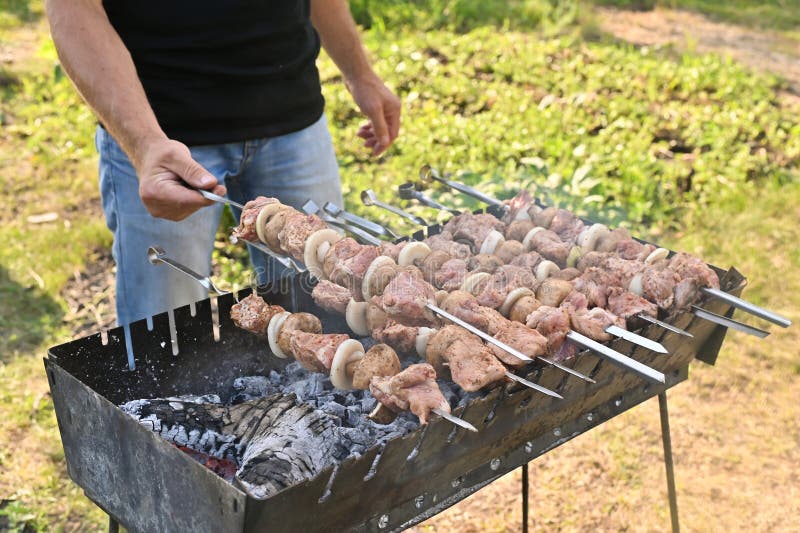 A Man Turns Over a Skewer with a Barbecue on the Grill Stock Photo ...
