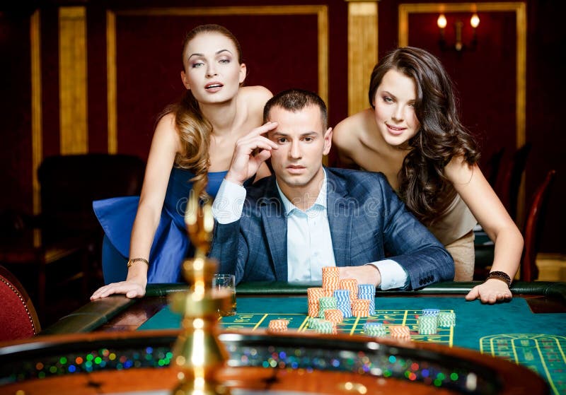 Man with Two Ladies Playing Roulette at the Casino Stock Image - Image ...