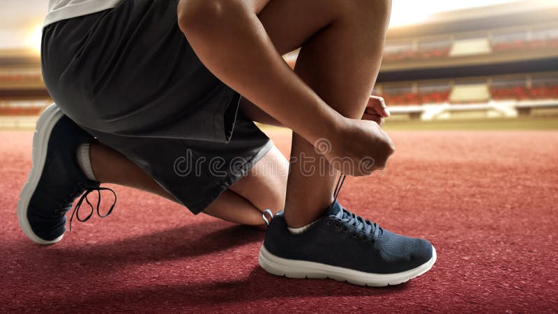 Man Tying Running Shoes on Racing Track Stock Photo - Image of lace ...