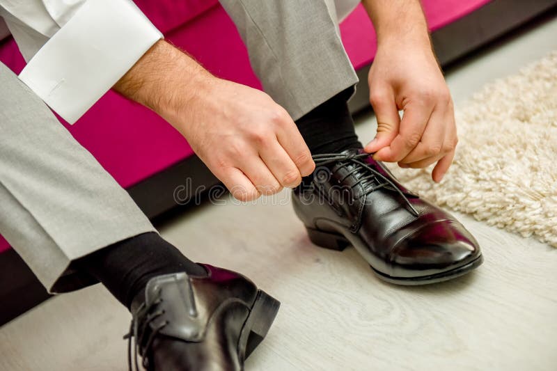 Man tying shoelaces shoes stock photo. Image of closeup - 69820562