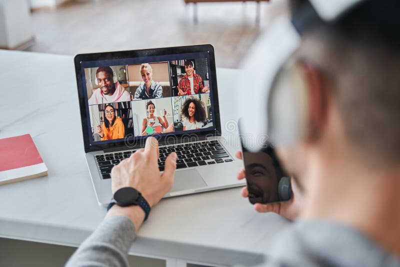 Man Typing at the Keyboard of His Computer while Having Zoom Conference ...