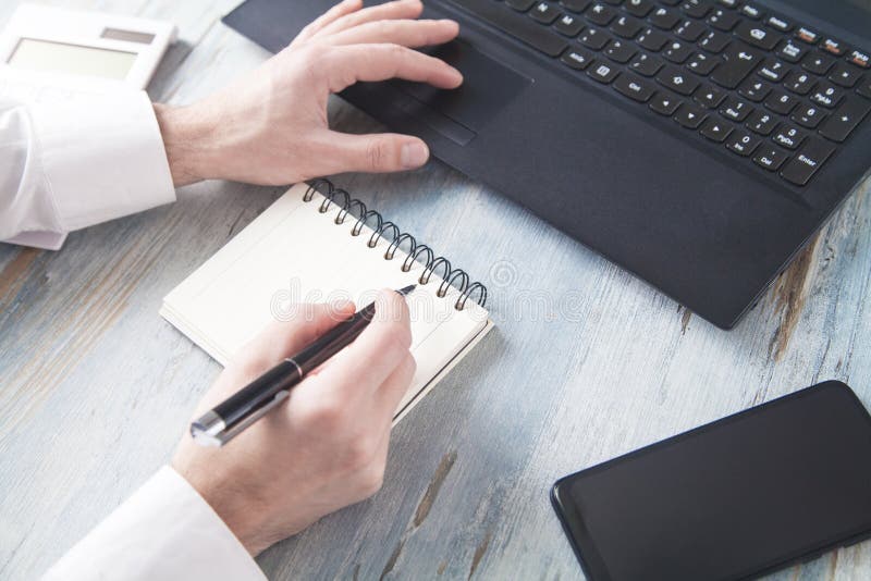 Man Typing in Keyboard and Writing on Notepad Stock Photo - Image of ...