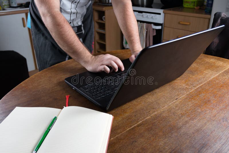 Man Typing on a Laptop Computer in Vintage Kitchen Stock Image - Image ...
