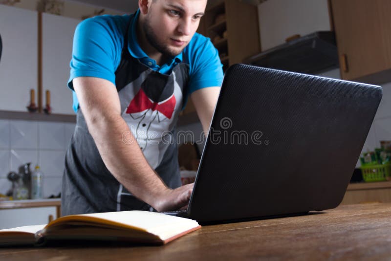 Man Typing on a Laptop Computer in Vintage Kitchen Stock Image - Image ...