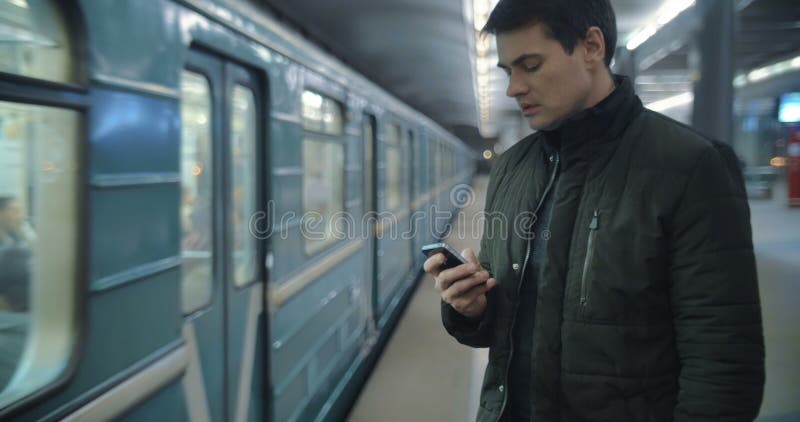 Man Typing Sms Standing on the Subway Platform Stock Image - Image of ...