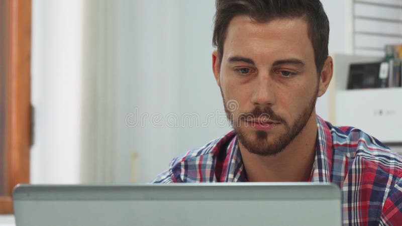 A Serious Guy Type Something on the Keyboard on the Computer Stock ...