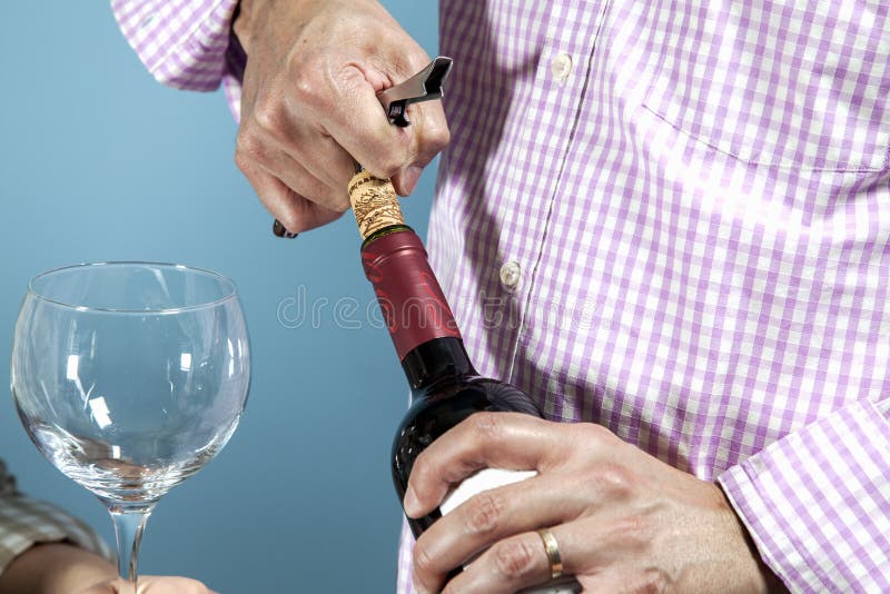 A Man Uncorking a Bottle of Red Wine Stock Image - Image of festivity ...