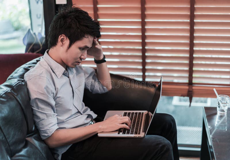 Man Under a Lot of Stress Using Laptop Computer in Cafe Stock Image ...