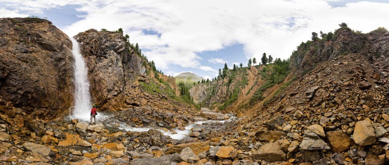 Man Under a Mountain Waterfall Stock Photo - Image of people, person ...