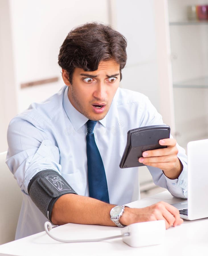 Man Under Stress Measuring His Blood Pressure Stock Photo - Image of ...
