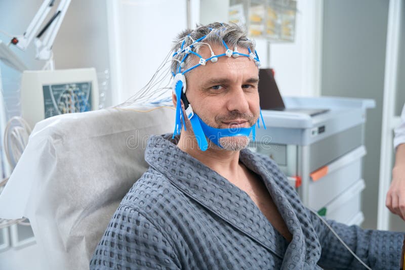 Man Undergoes An Eeg Examination Electroencephalography In Medical