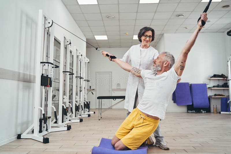 Man Undergoing the Physiotherapy Supervised by a Qualified Physiatrist ...