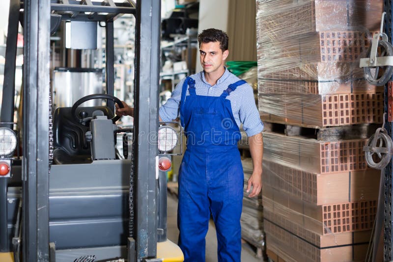 Man in Unifom is Using Cargo Moving Machine in the Building Store Stock ...