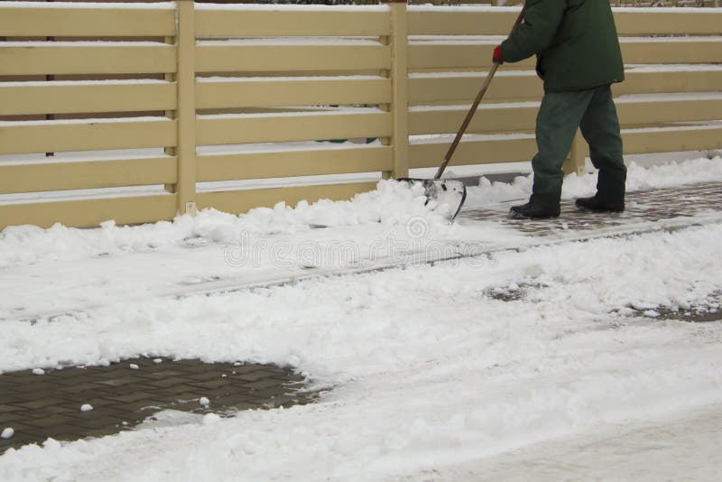 Man in Uniform Cleaning Snow with a Shovel Stock Image - Image of ...