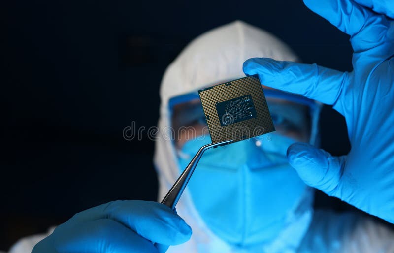Man in Uniform Holds Microprocessor with Forceps Stock Photo - Image of ...