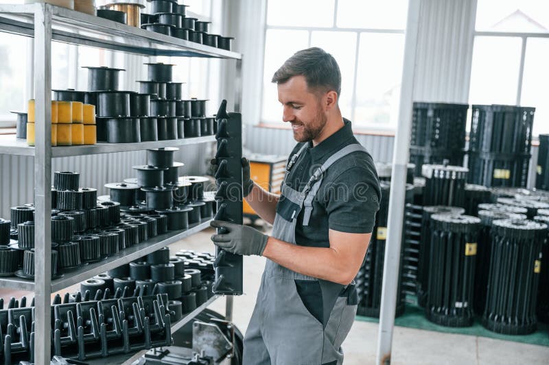 Man in Uniform is in Workstation Developing Details of Agriculture ...