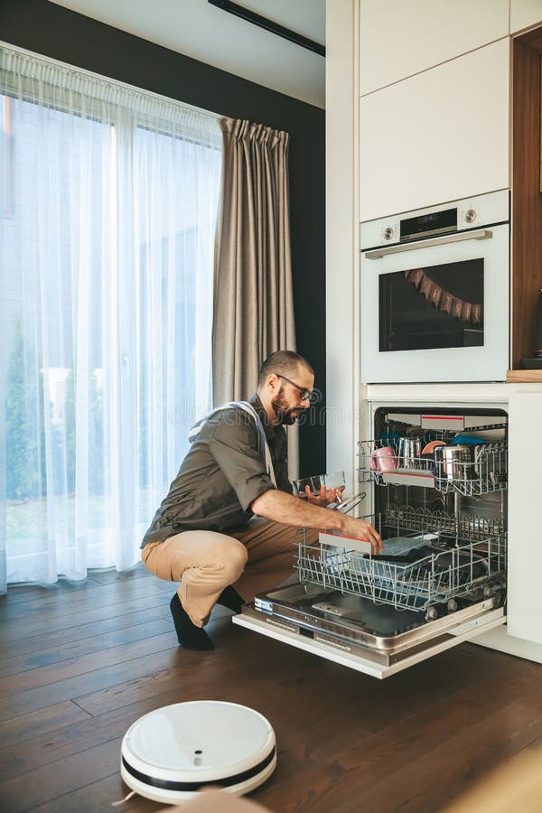 The Man Unloading Dishwasher Stock Image - Image of male, kitchen ...