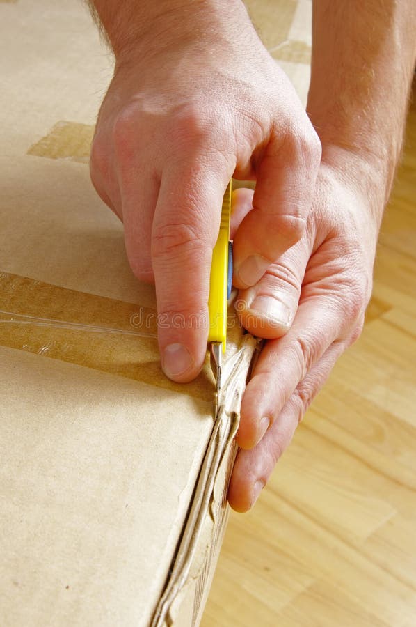 Man unpacking box stock photo. Image of unpacking, cutter - 18694844