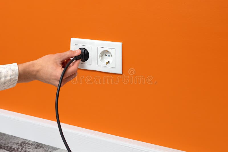 Man Unplugging Cord from a Electrical Outlet Stock Photo - Image of ...