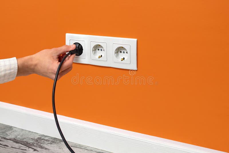 Man Unplugging Cord from a Electrical Outlet Stock Photo - Image of ...