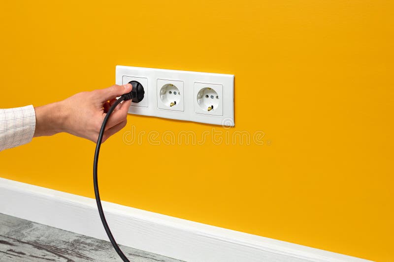 Man Unplugging Cord from a Electrical Outlet Stock Photo - Image of ...